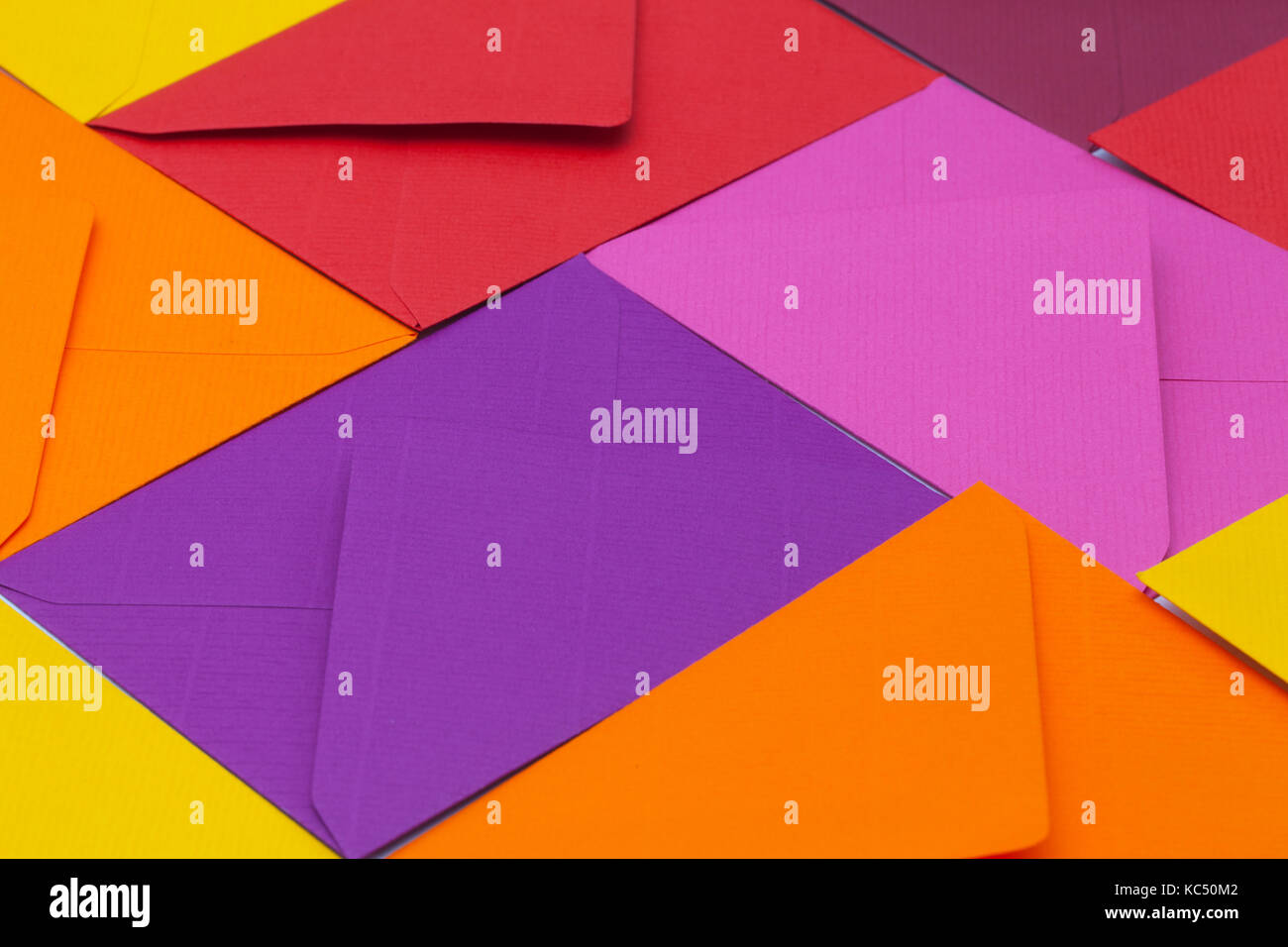 Different colored envelopes on the table Stock Photo - Alamy