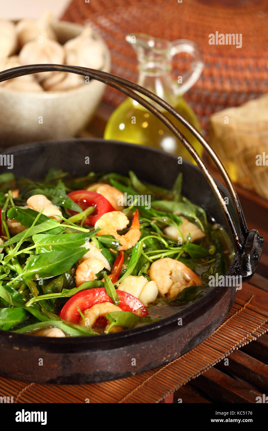 Delicious and healthy seafood water spinach dish served in a hot plate ...