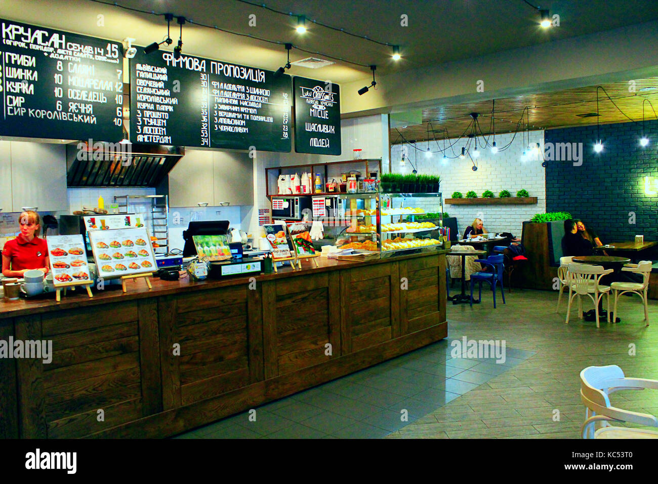 two waiters speak to each other in a cafe where they make delicious ...