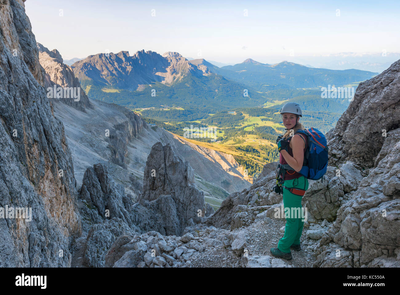 Hiker on the Santner via ferrata, panoramic view of the Latemar Group ...