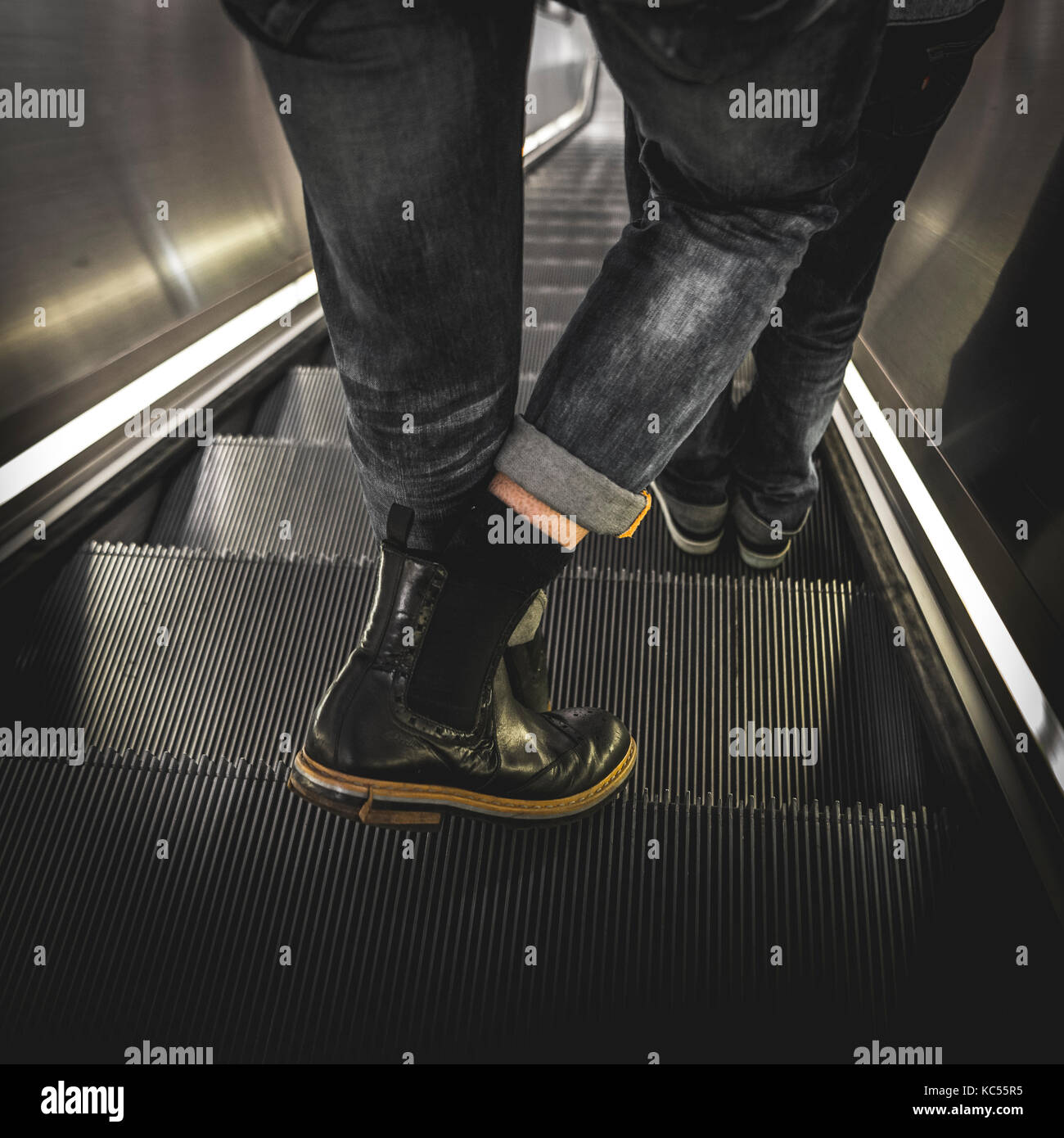 Legs, shoes of a man standing on escalator, London, England, Great ...
