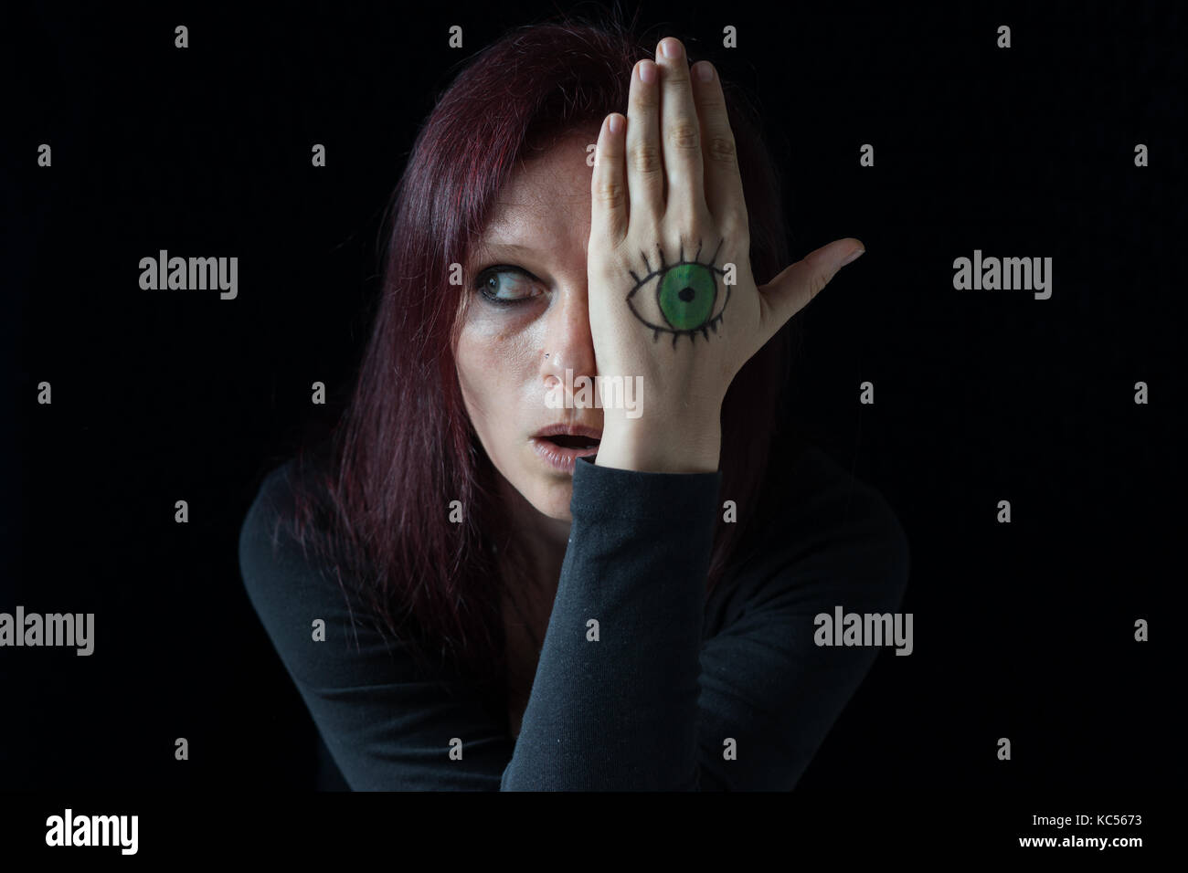 Woman with painted eye on her hands Stock Photo - Alamy