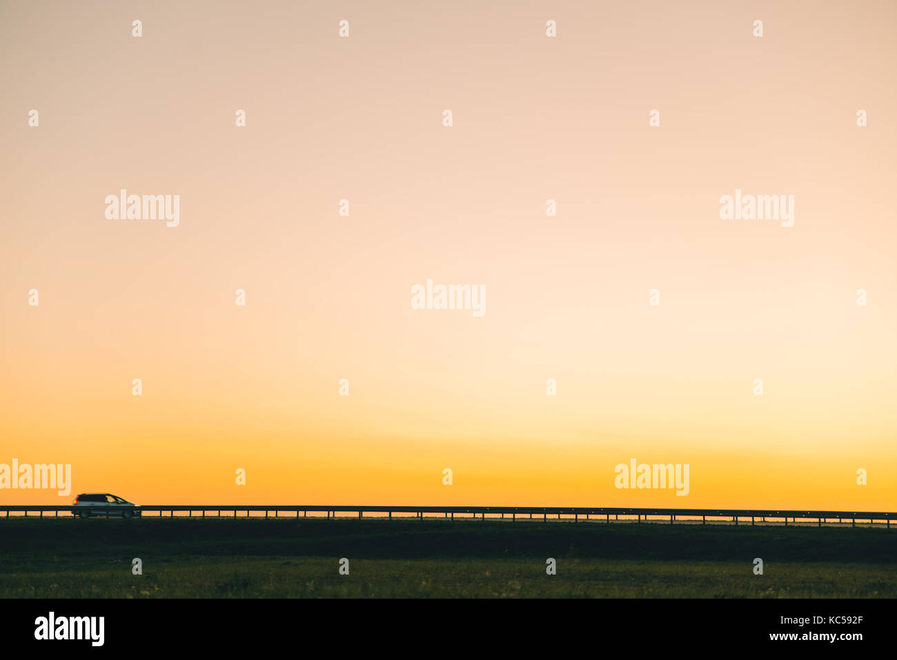 car on highway on sunset horizont view Stock Photo - Alamy
