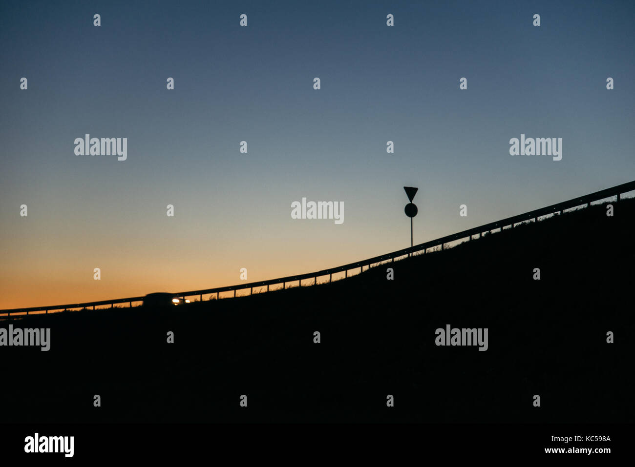sunset on highway silhouette of the road Stock Photo - Alamy
