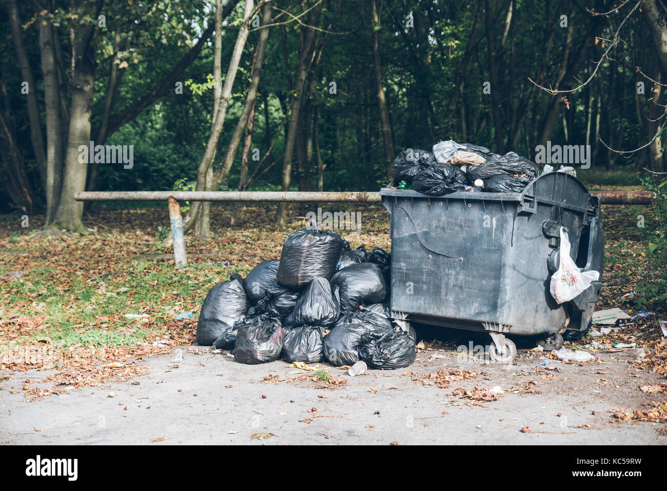 Full garbage containers outside on the street Stock Photo - Alamy