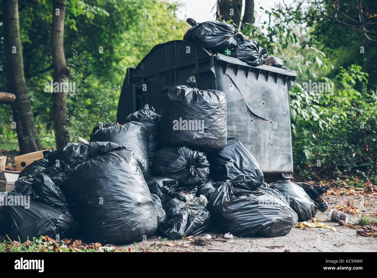 Full garbage containers outside on the street Stock Photo - Alamy