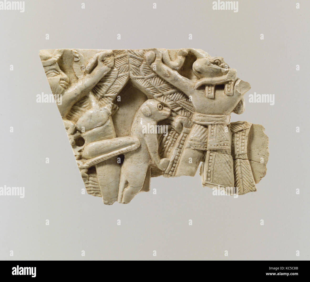 Plaque fragment with a monkey and a locust between a winged figure and ...