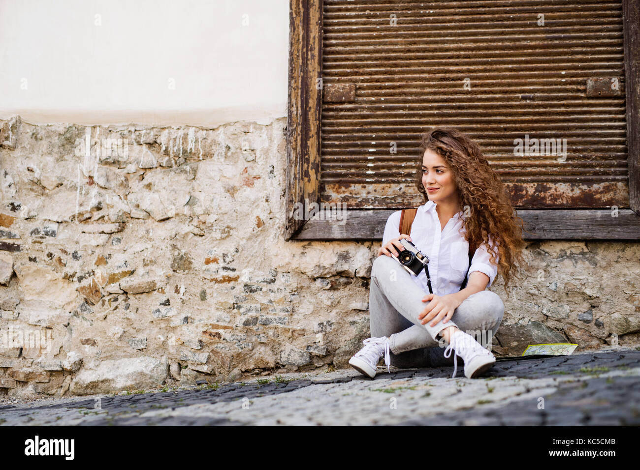 Beautiful young tourist with camera in the old town Stock Photo - Alamy