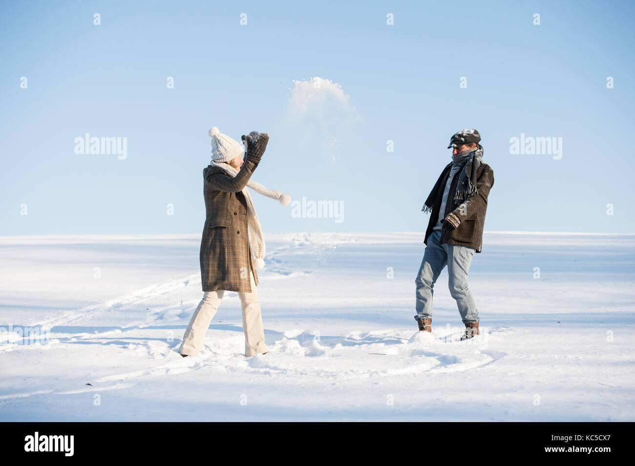Beautiful senior couple on a walk in sunny winter nature Stock Photo ...