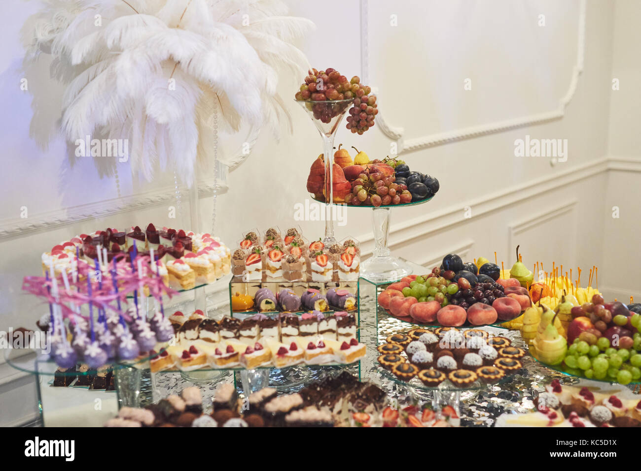 The vases with fruits stand on the buffet table Stock Photo - Alamy