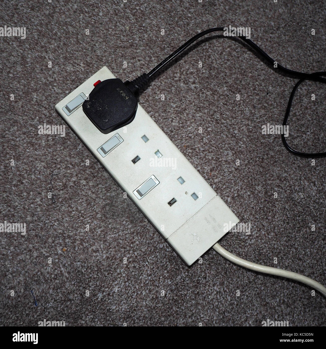 White plug board Extension Lead on office floor Stock Photo - Alamy