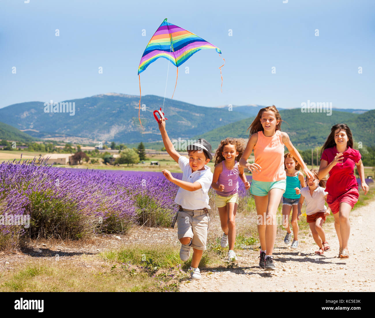 Smiling boy running through field hi-res stock photography and images ...