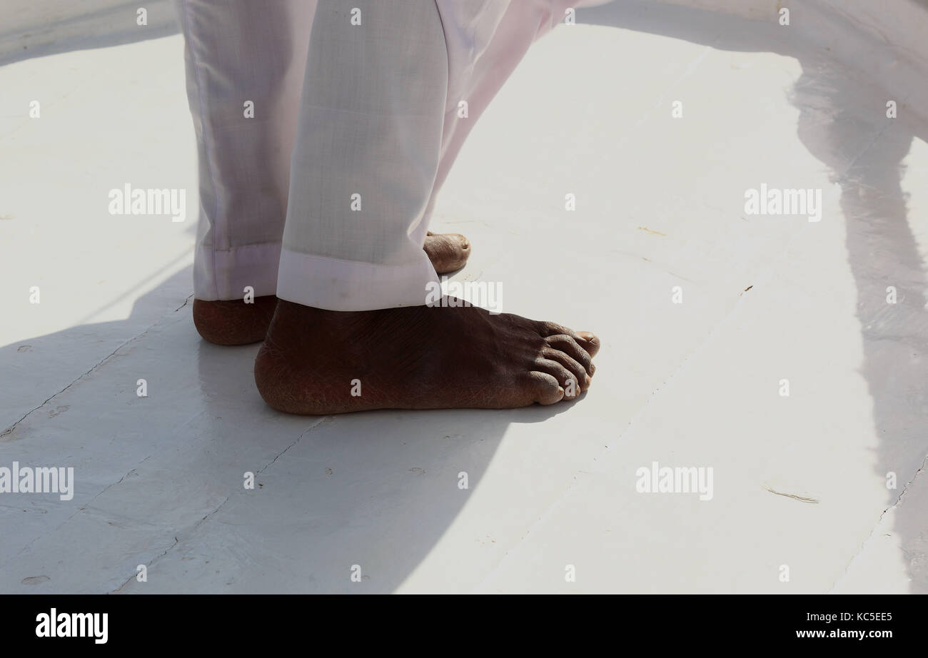 Brown feet standing on white ground, Egypt Stock Photo - Alamy