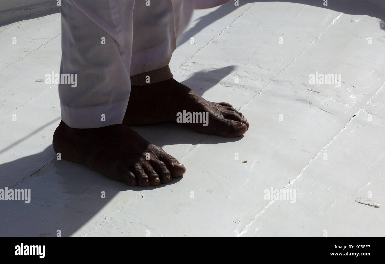 Brown feet standing on white ground, Egypt Stock Photo - Alamy