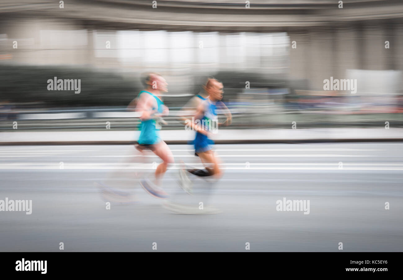 Blurry scene of unknown running men competed on road in fast motion ...