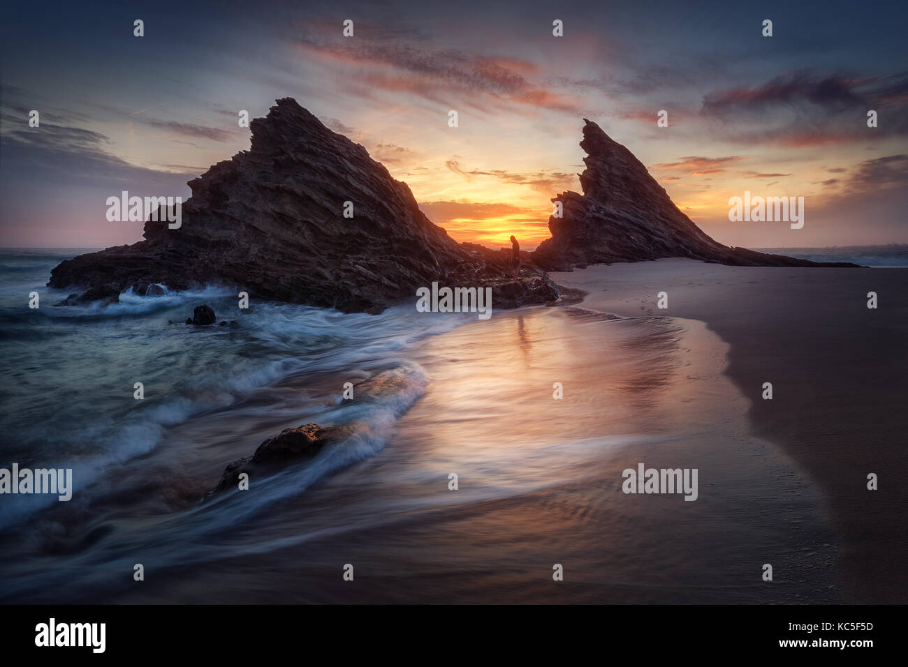 Photographer at sunset in Samoqueira beach, near Porto Covo, in ...