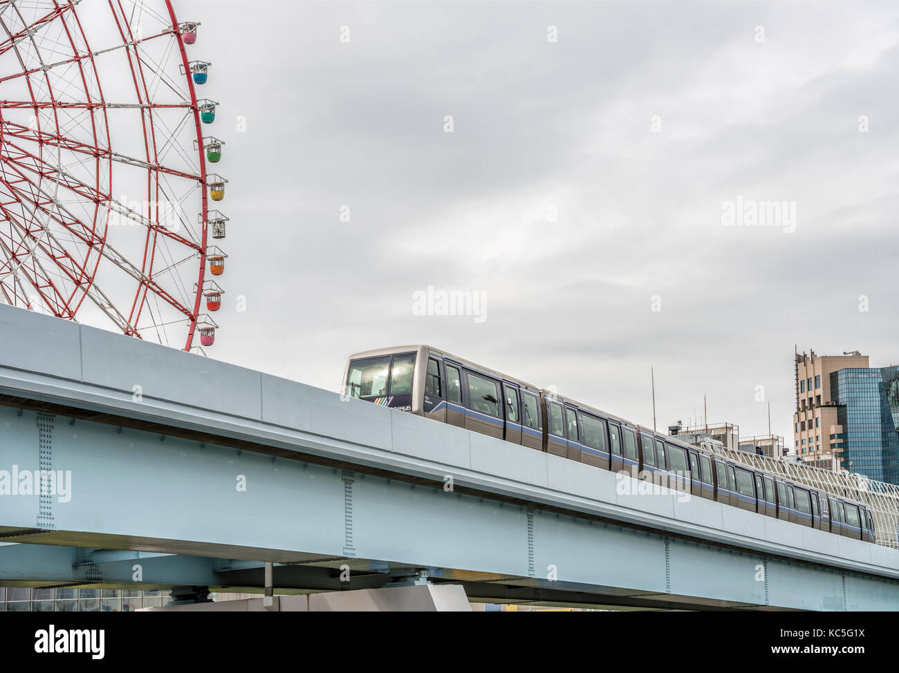 Yurikamome Monorail train in front of the Palette Town Building and ...