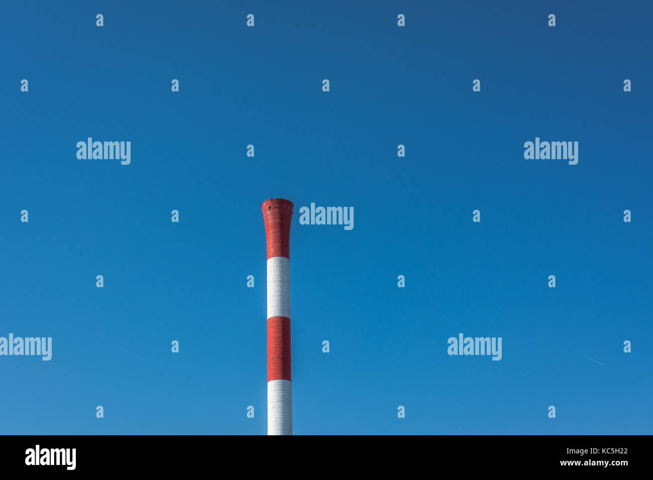 Factory chimney red white color on blue sky background left align Stock ...