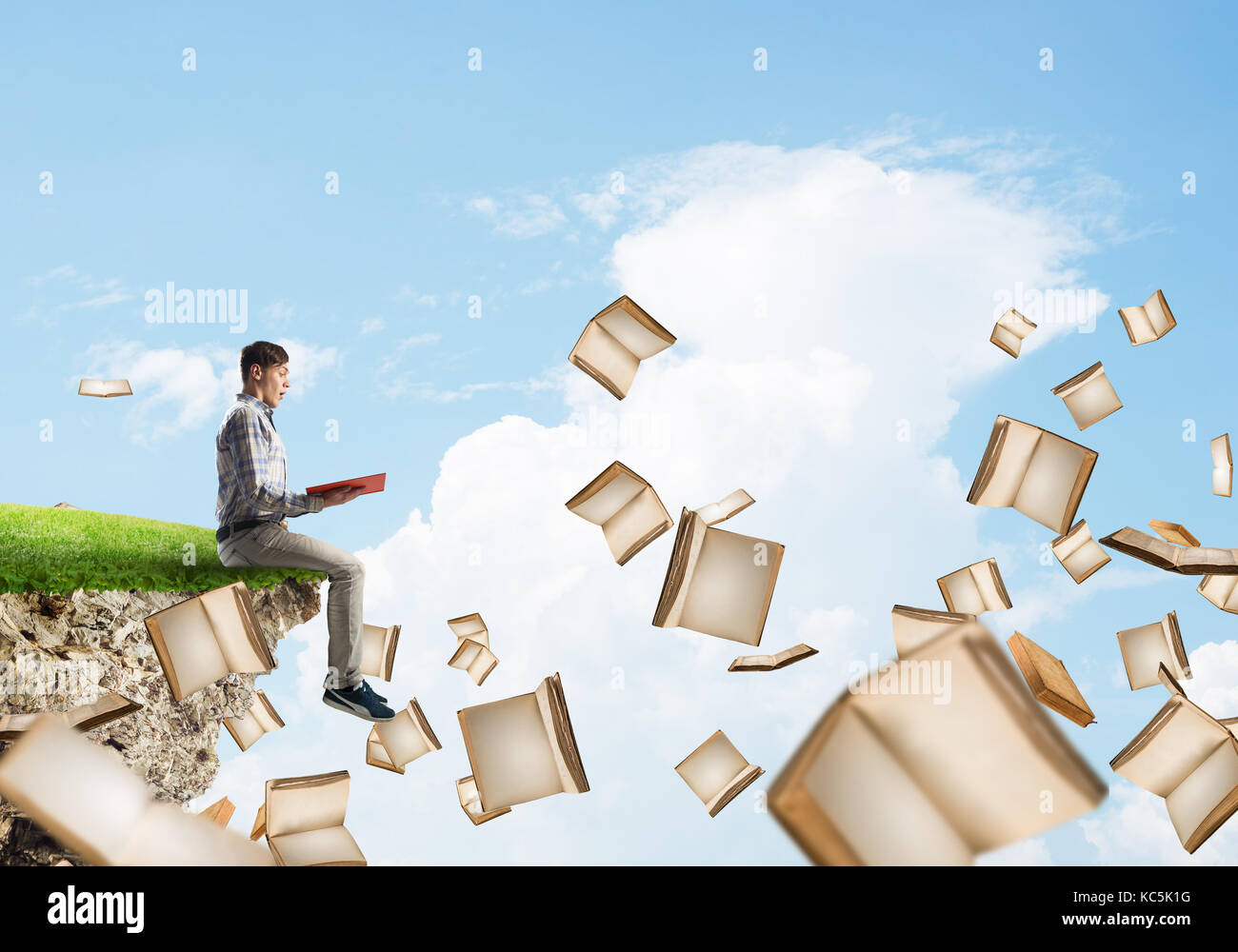 Man reading book and many of them flying in air Stock Photo - Alamy
