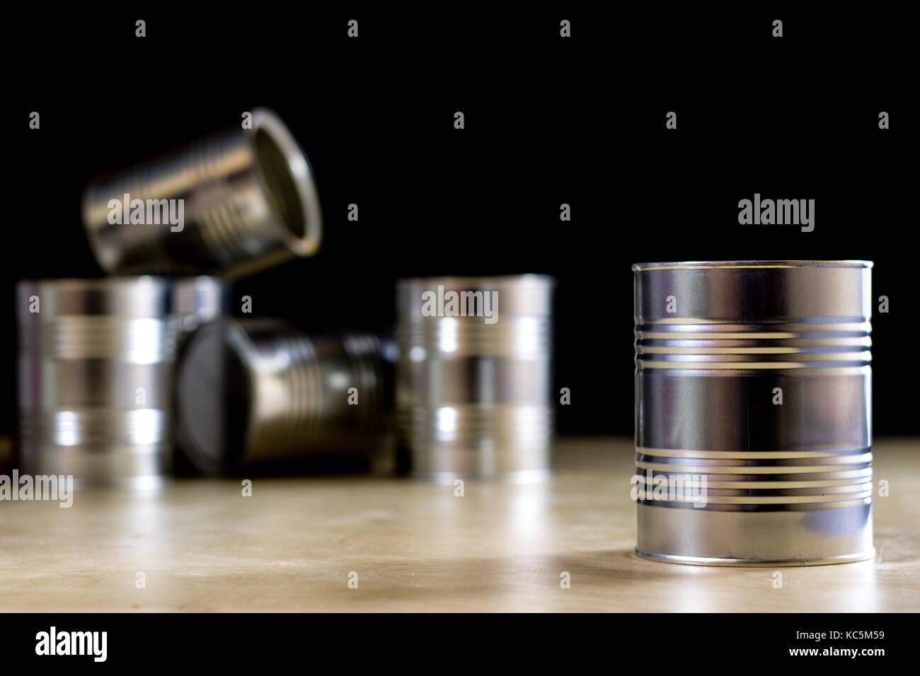 Paint tins set on a workshop table. Table with light wood, black ...