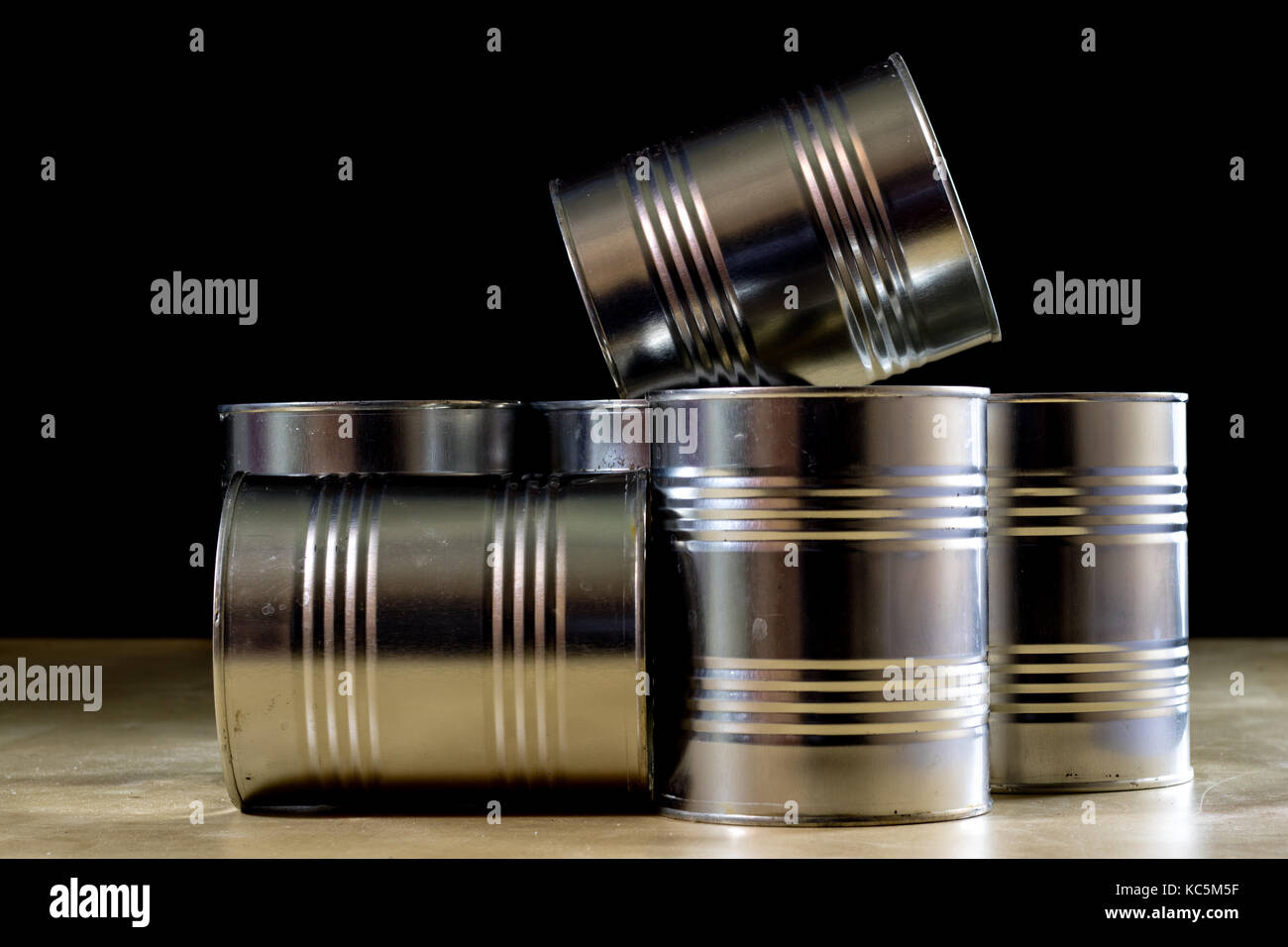 Paint tins set on a workshop table. Table with light wood, black ...
