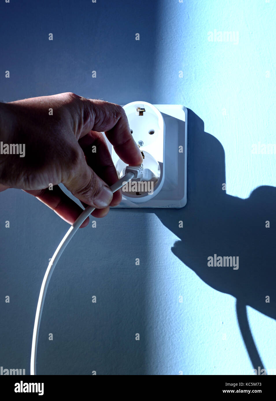 Hand pulls plug hi-res stock photography and images - Alamy