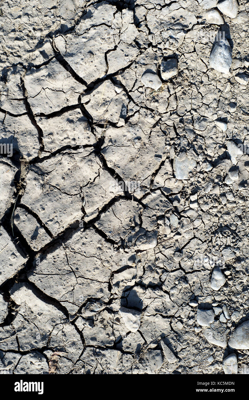 Cracked and broken dry mud dried from hot sun with textures of a ...