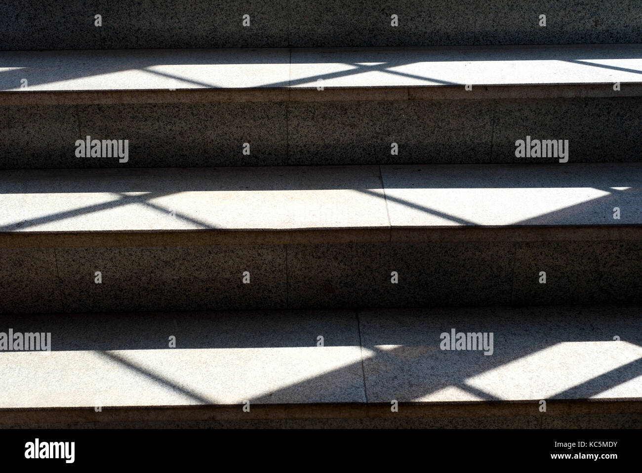 Concrete steps in natural sunlight with diagonal geometric shadows in ...