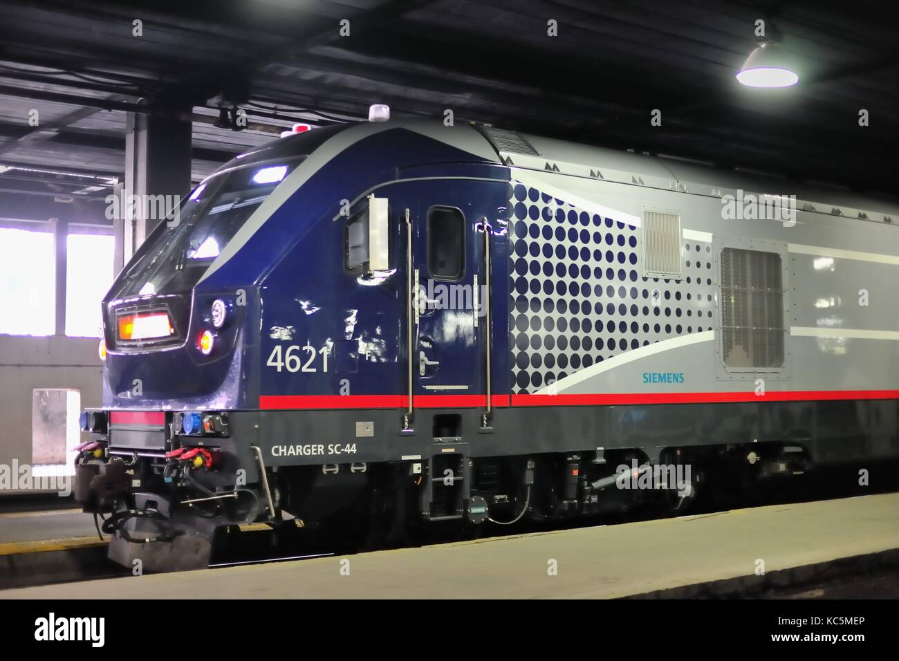 An Amtrak SC-44 locomotive leading a passenger train awaiting departure on a track inside the ...