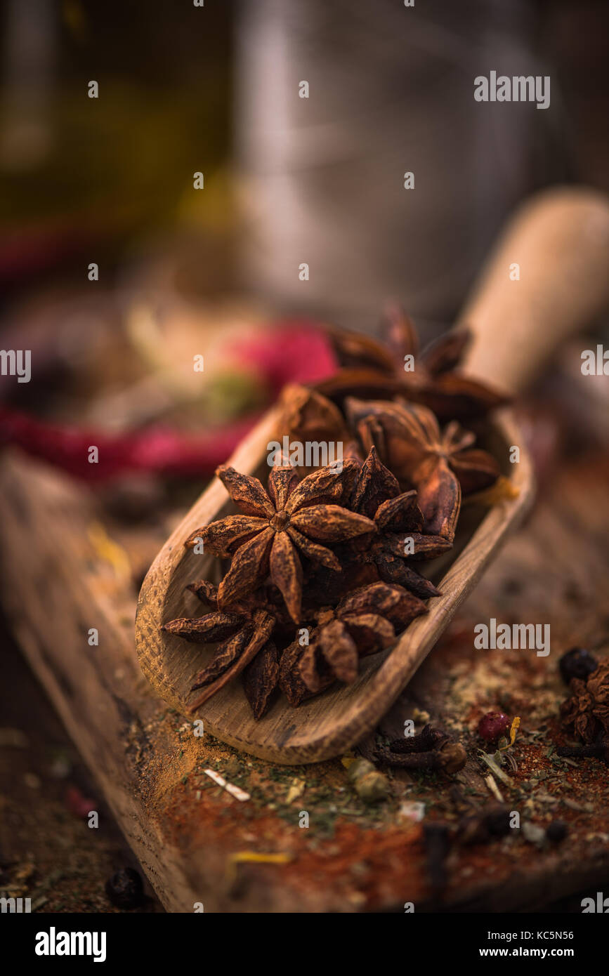 Whole anise stars on wooden spoon Stock Photo - Alamy