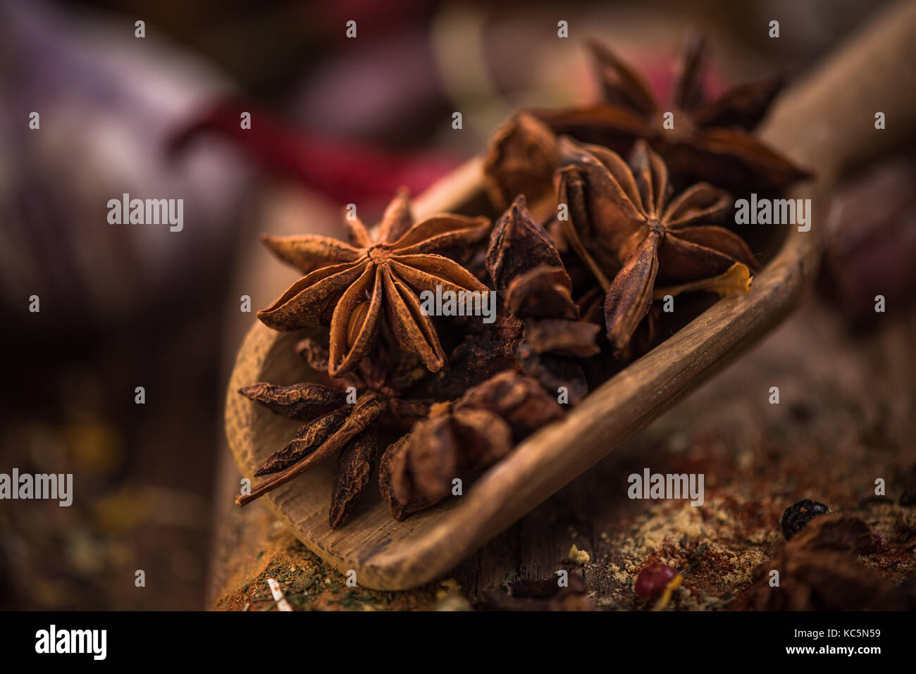 Whole anise stars on wooden spoon Stock Photo - Alamy
