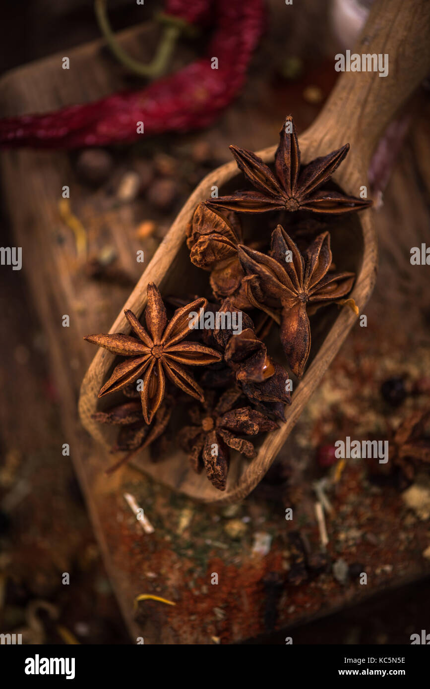 Whole anise stars on wooden spoon Stock Photo - Alamy