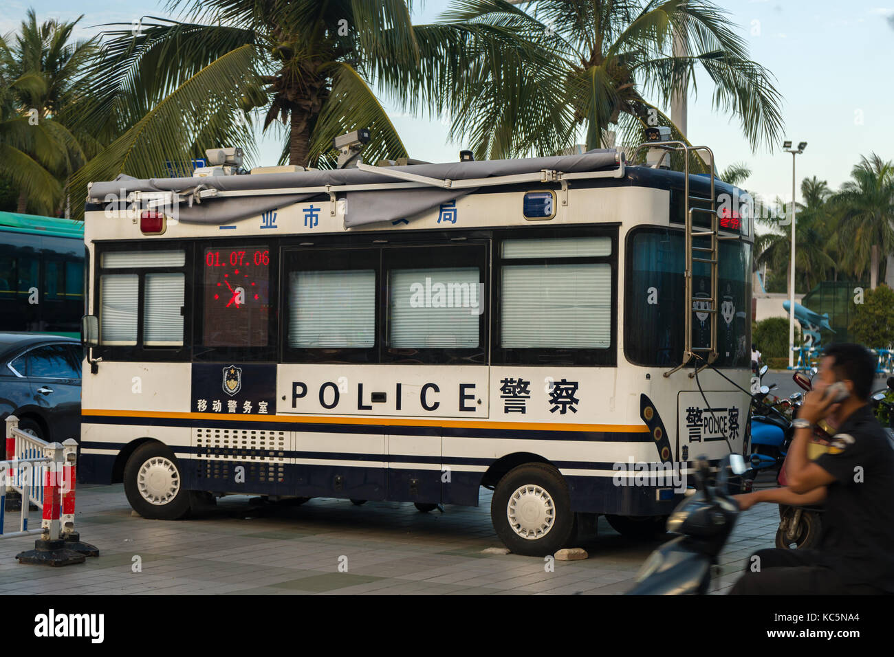 Police bus is charging from the power grid in the tourist city of Sanya ...