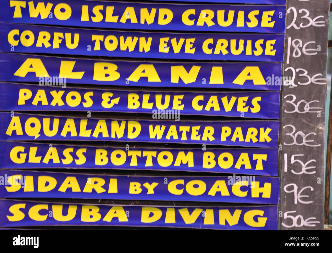 a painted sign written noticeboard advertising coach and boat trips to ...