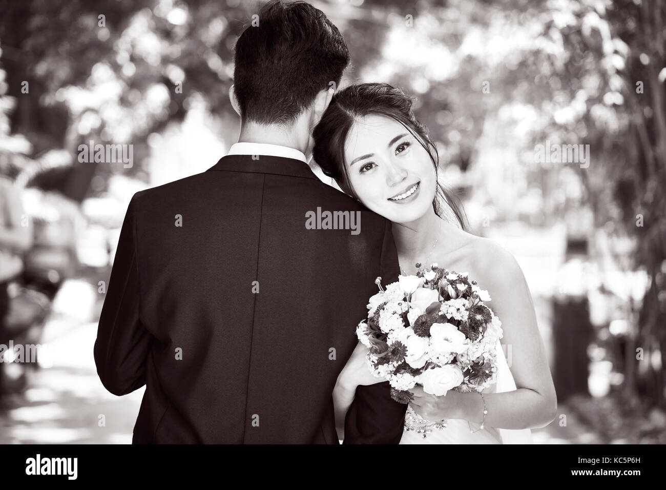 portrait of young asian bride and groom at wedding ceremony, black and ...