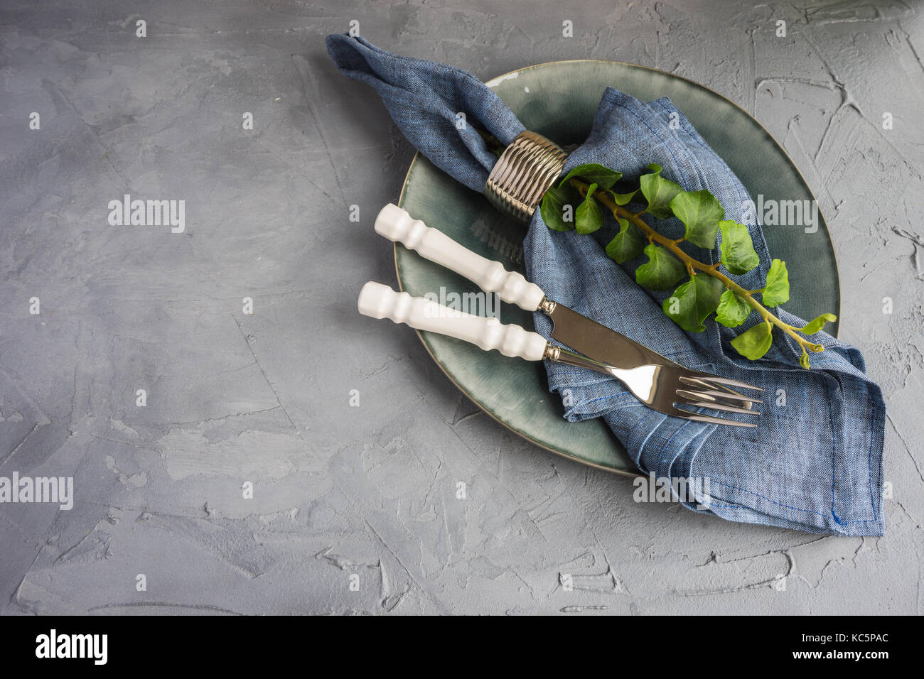 Rustic table setting with vintage ceramic plates and branch of ivy ...