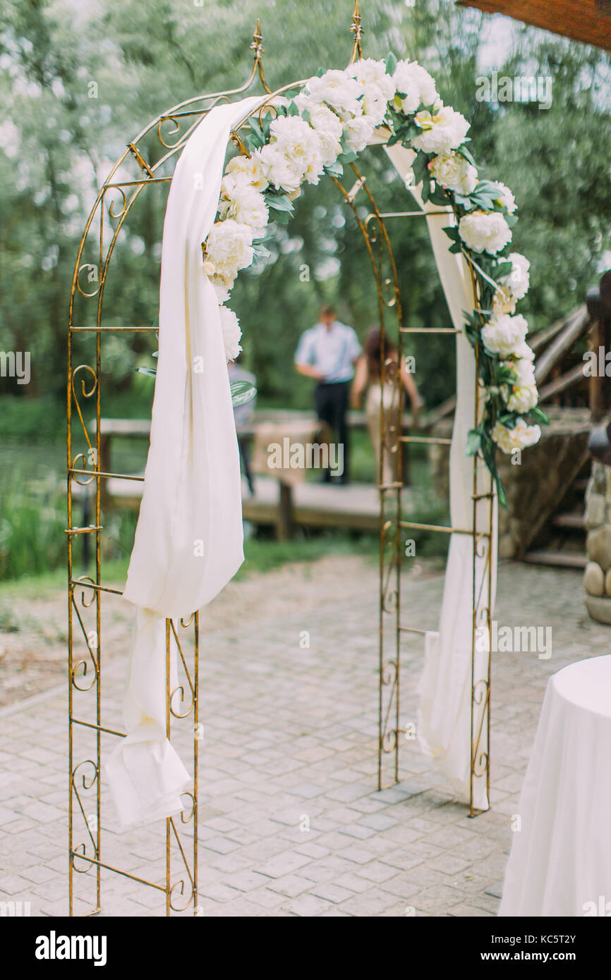 The side view of the wedding arch decorated with white flowers Stock ...