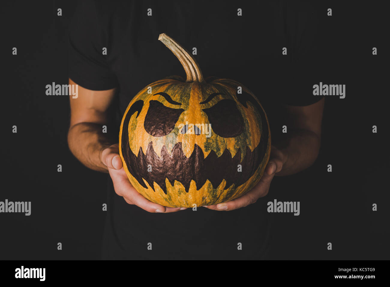 Pumpkin in male hands hi-res stock photography and images - Alamy