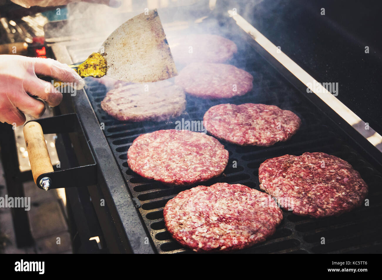 Frozen burger in the cook hand ready for preparing. Round patties of ...