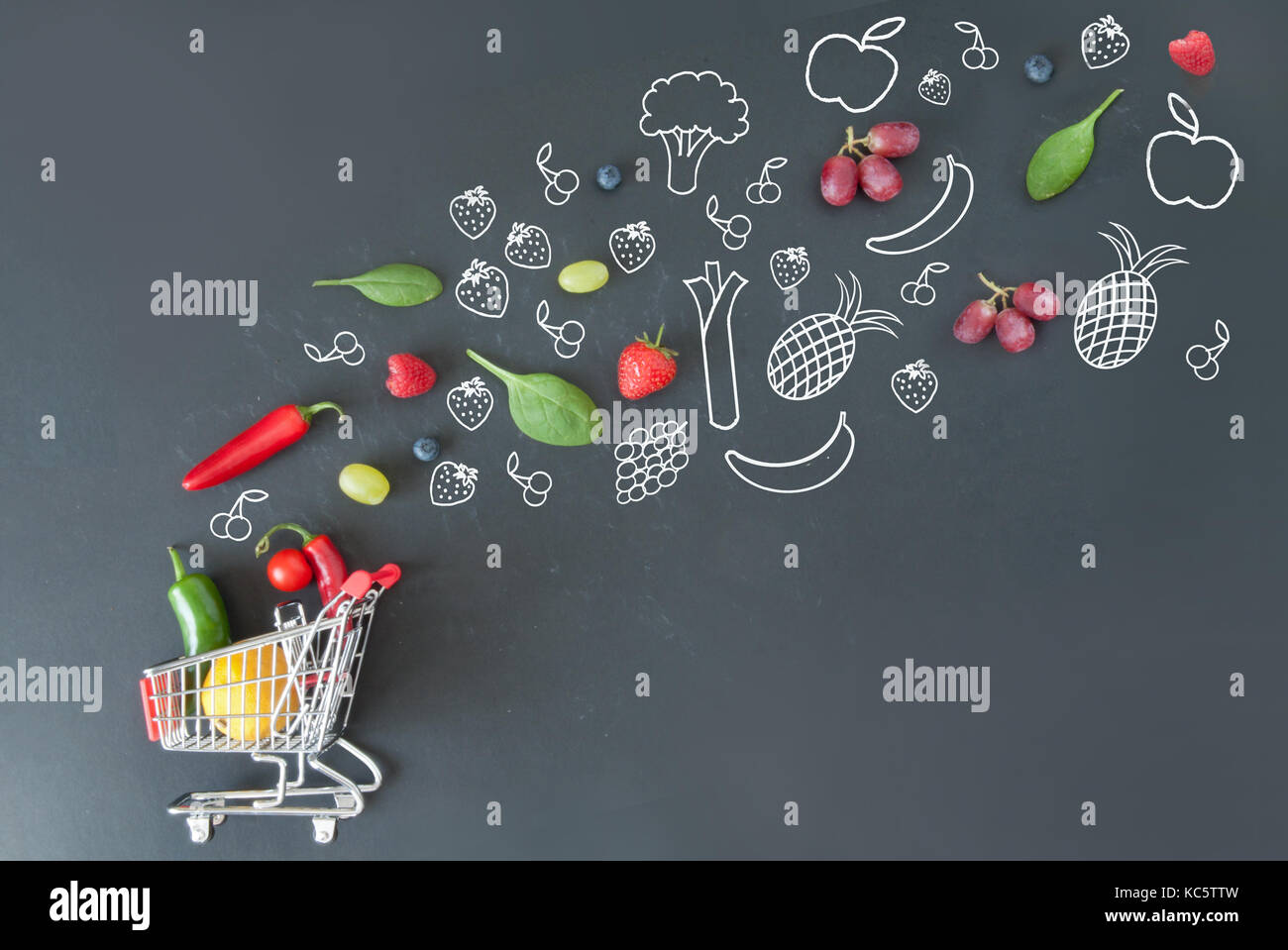 Grocery shopping cart filled with fruits and vegetables and sketches on ...