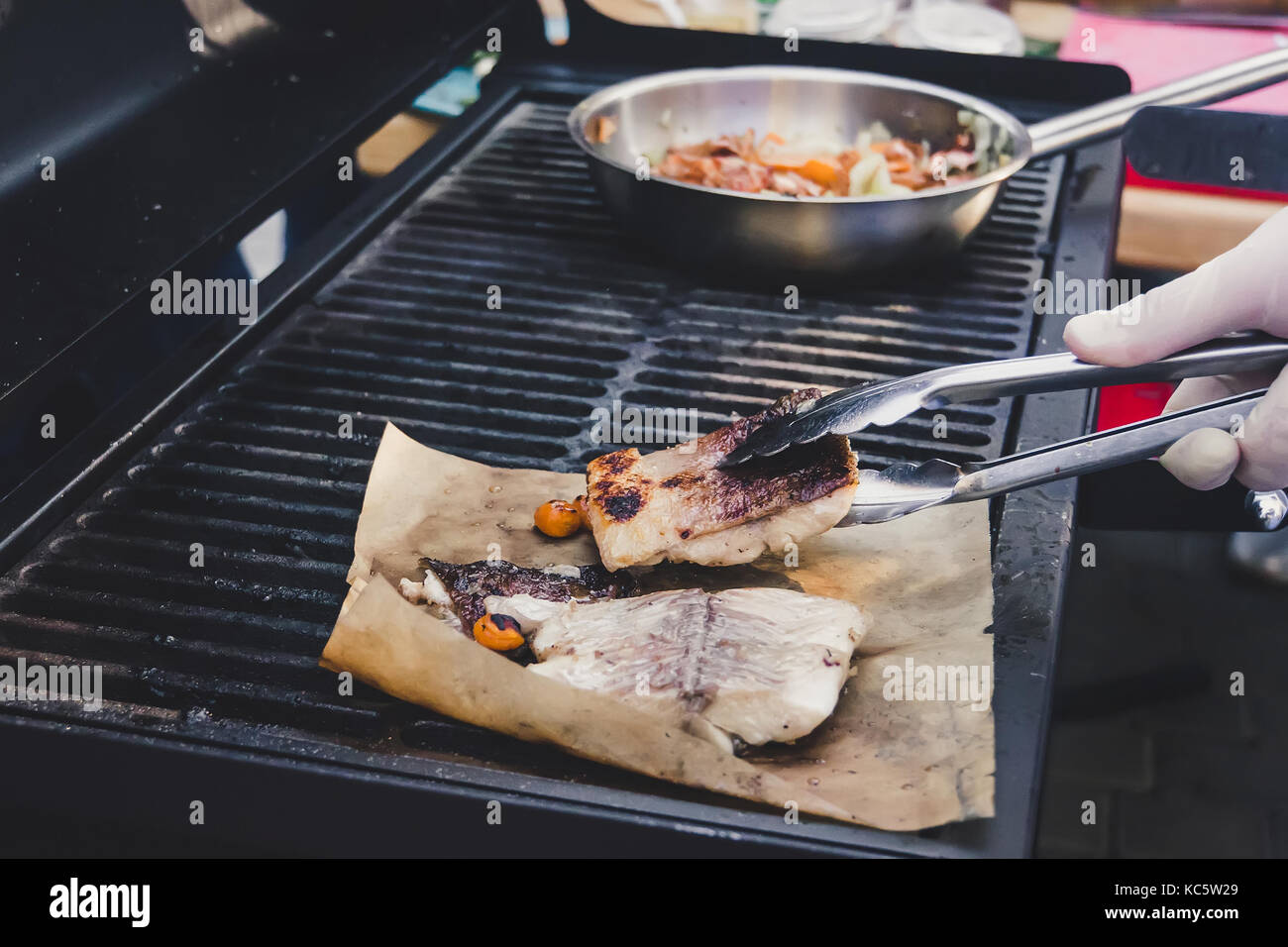 Hand of man take cooking of fish with vegetable grill, Chef cooking ...