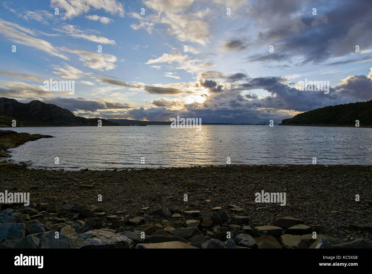 Sunset across Loch Diabaig from the rocky beach at Lower Diabaig, with ...