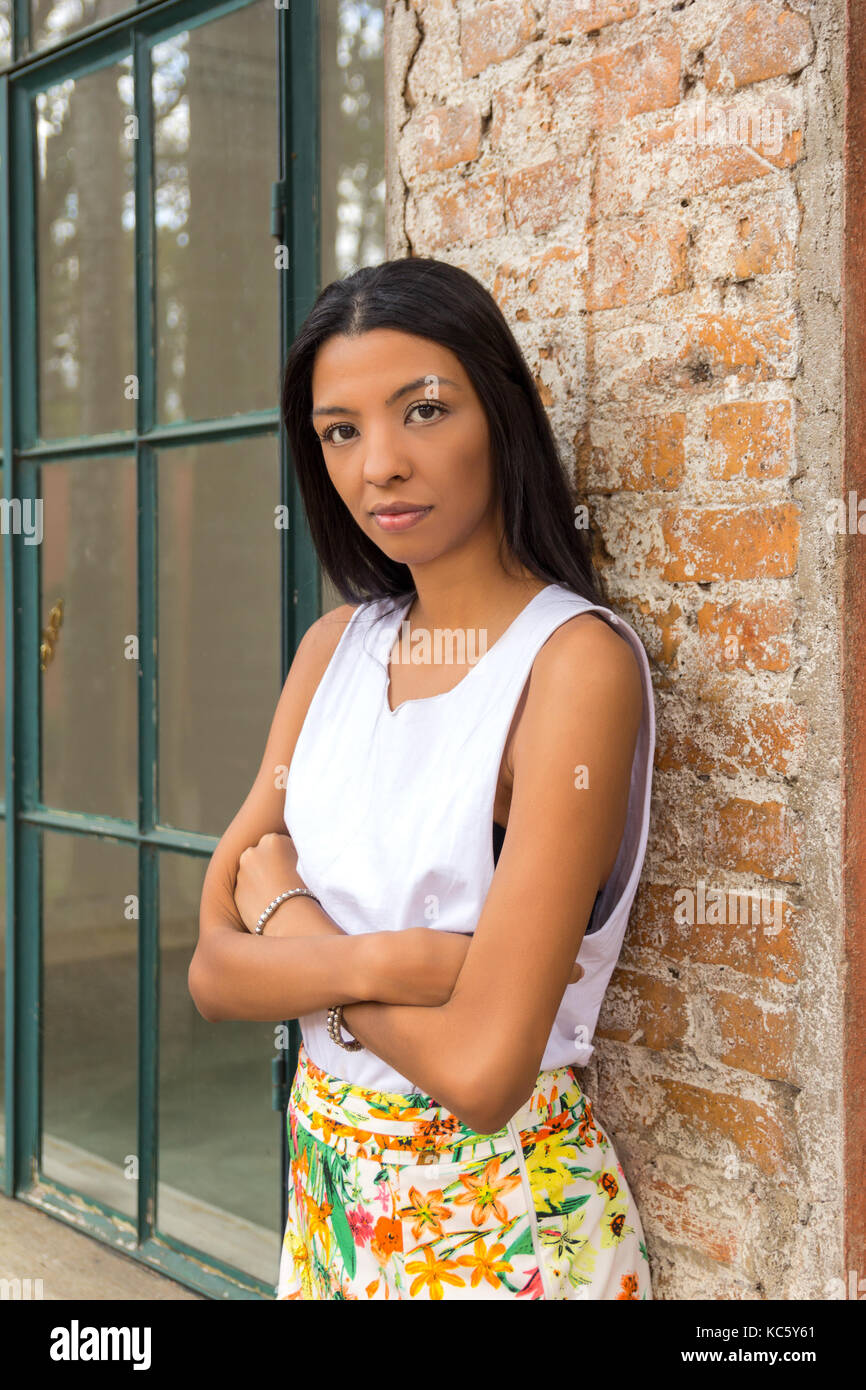 Young confident woman in tropical rustic feel. She is thin and pretty ...