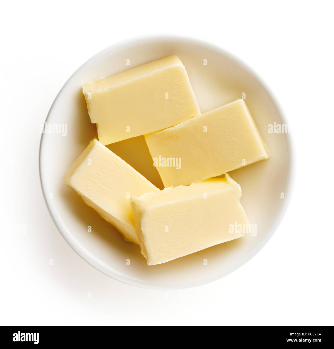 Butter pieces in bowl isolated on white background, top view Stock ...