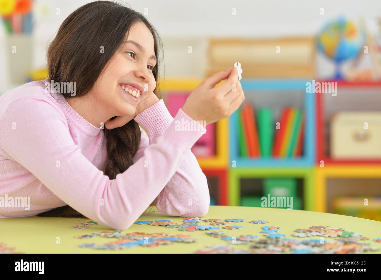 girl collecting puzzles Stock Photo - Alamy