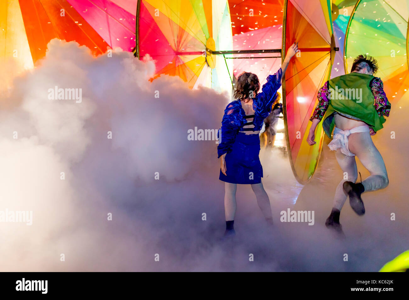 Street festival performers dancing in front of a crowd of people with ...