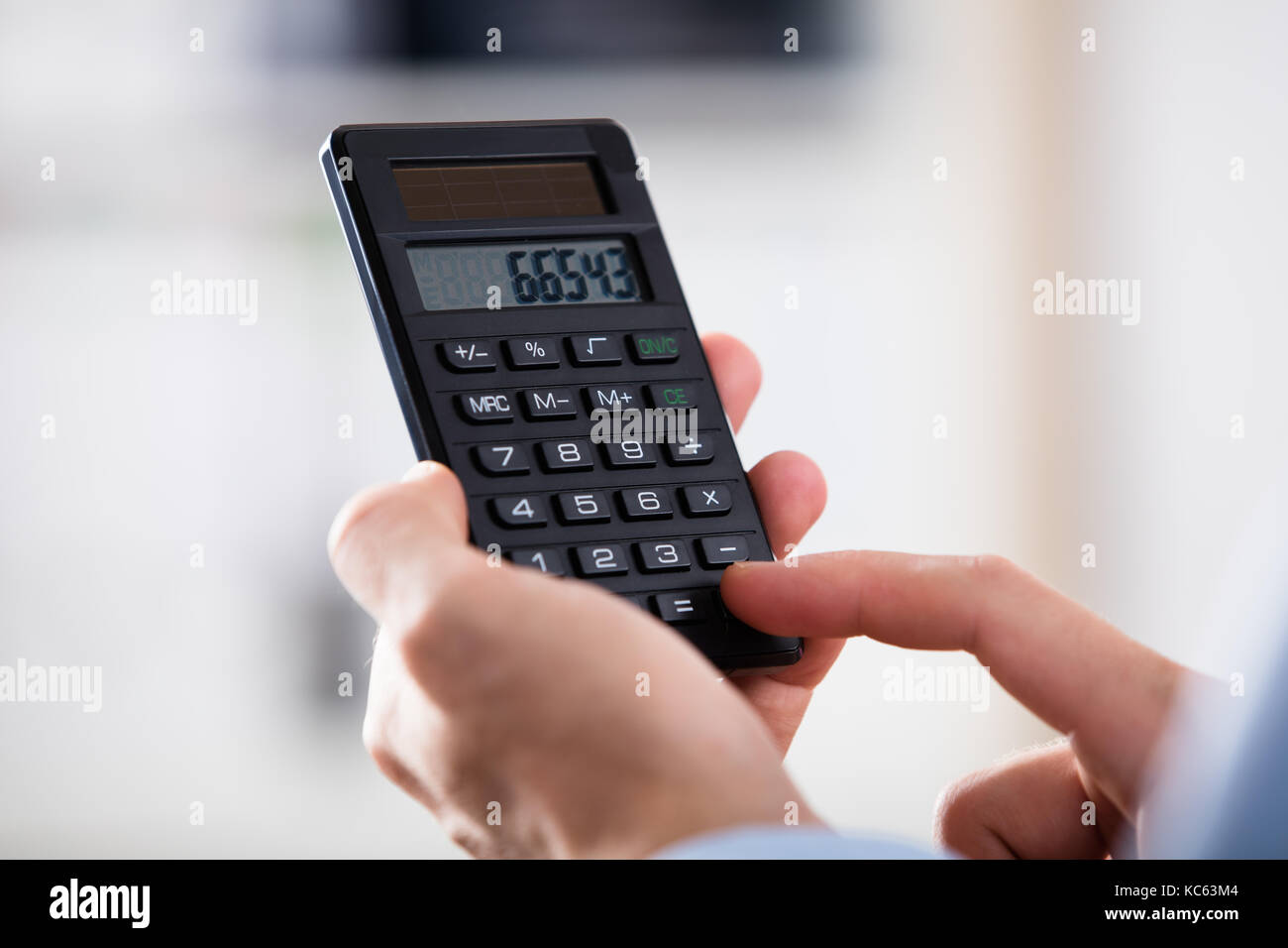 Close-up Of A Person Doing Calculation On Calculator Stock Photo - Alamy