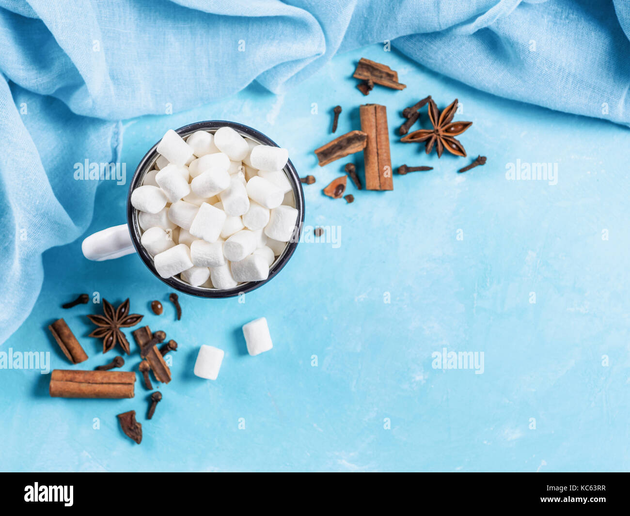 Marshmallows and winter spices on blue background Stock Photo - Alamy