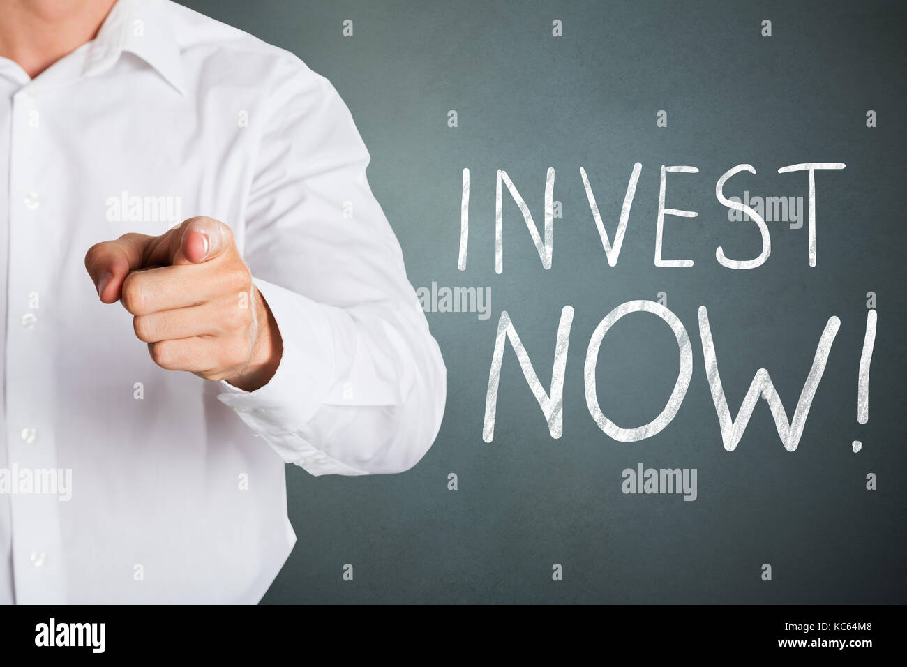 Invest Now Text With Business Man Pointing Toward Camera Stock Photo ...