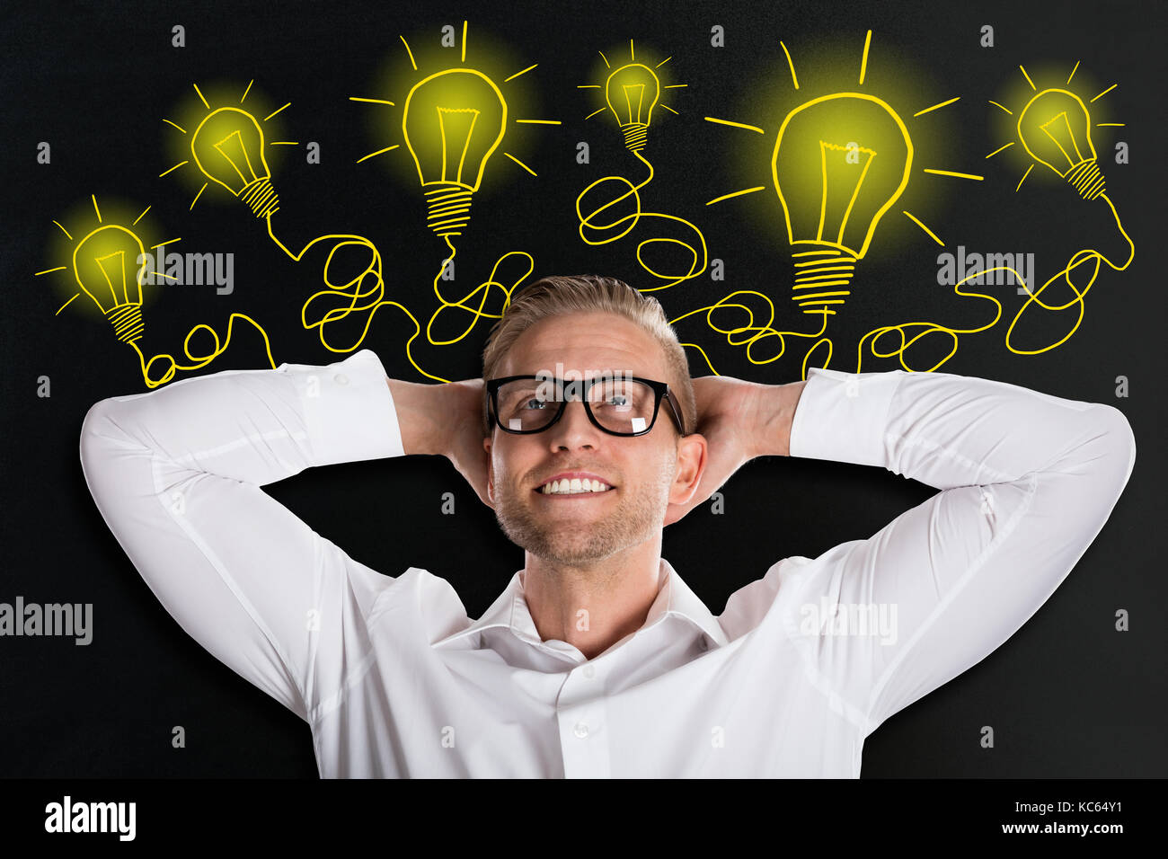 Handsome Smiling Young Man Looking Up With Creative Light Bulb Sketches ...